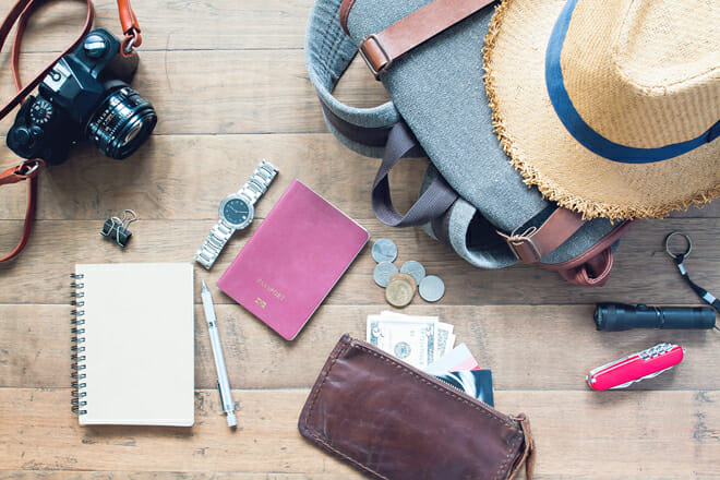 overhead view of man's accessories, traveler items on wooden bac