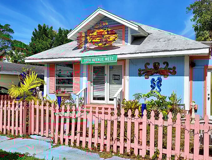 A cheerful cottage with a pink picket fence welcomes visitors to Bradenton's Village of the Arts, where whimsy reigns supreme.
