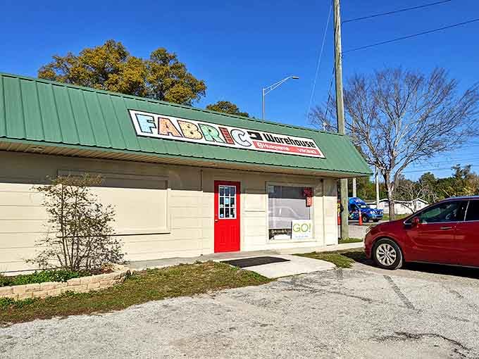 The unassuming exterior of Fabric Warehouse belies the creative wonderland within – like finding a treasure chest disguised as a shoebox.