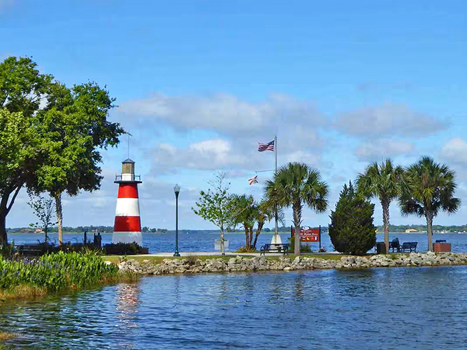 The iconic red and white stripes of Mount Dora's lighthouse pop against Florida's blue skies, creating a postcard-perfect scene at Grantham Pointe.