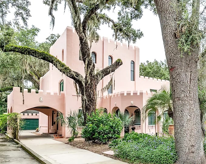 The Pink Castle stands proudly among Spanish moss-draped oaks, its salmon-colored walls and crenellated towers creating a fairytale vision in St. Augustine.