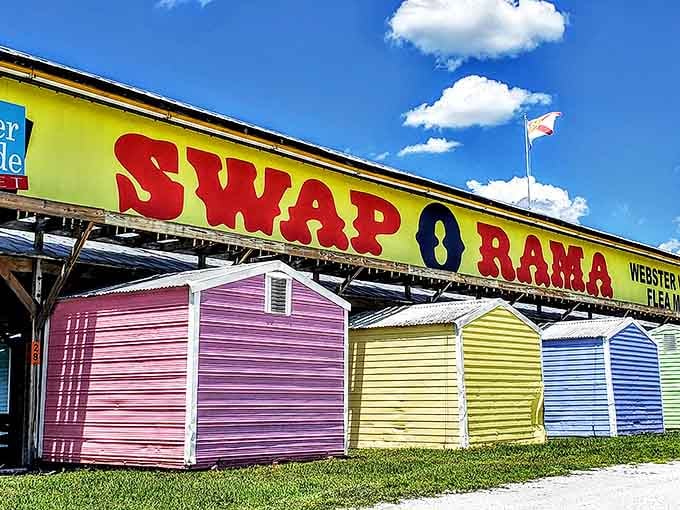 The iconic rainbow-colored sheds of Webster Swap-O-Rama stand bright against the Florida sky, promising treasures within each colorful structure.