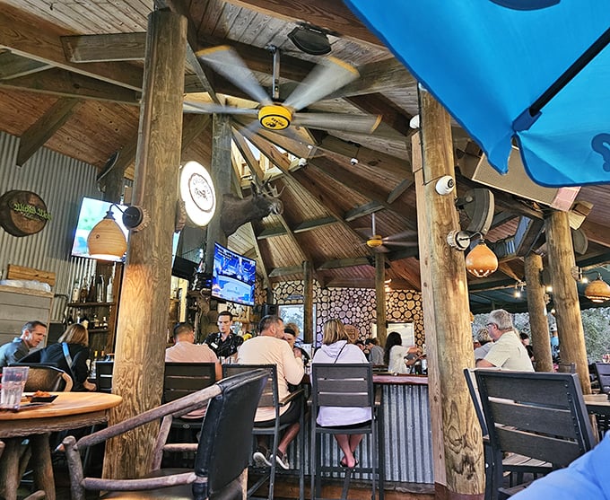 The treehouse bar area buzzes with conversation as patrons gather under wooden beams and rustic lighting to enjoy Norwood's extensive drink selection.