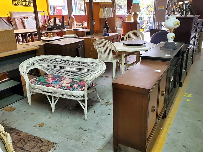 Mid-century furniture awaits new homes in this showroom corner, where wicker seating and wooden cabinets showcase timeless craftsmanship and design.