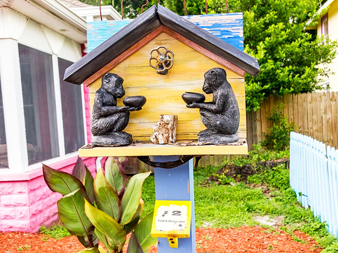 Monkey business is serious art in this whimsical shrine box, where simian figures offer bowls in a charming yellow house.