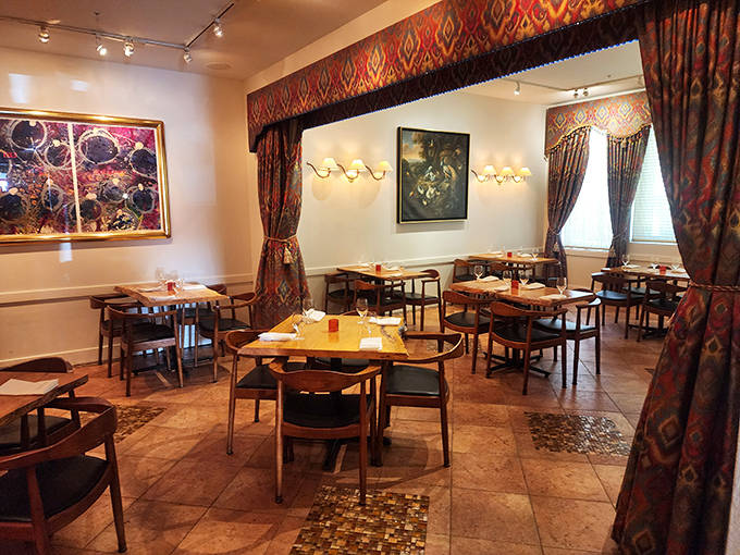 Rich fabrics and carefully curated artwork transform this dining area into a gallery where the food is the most impressive exhibit.