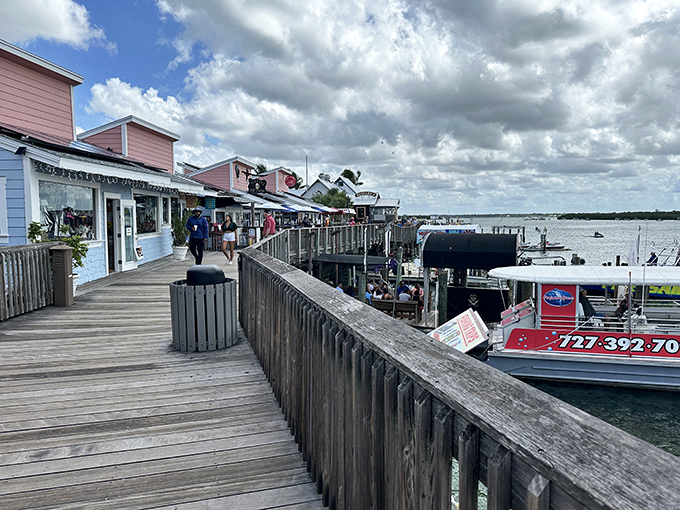 The wooden boardwalk stretches invitingly along the waterfront, promising adventures with every weathered plank and salt-kissed breeze.