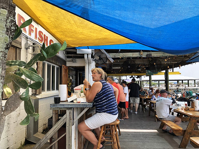 Under colorful umbrellas, diners enjoy the ritual of fresh seafood with water views&mdash;no reservation required, just good timing.