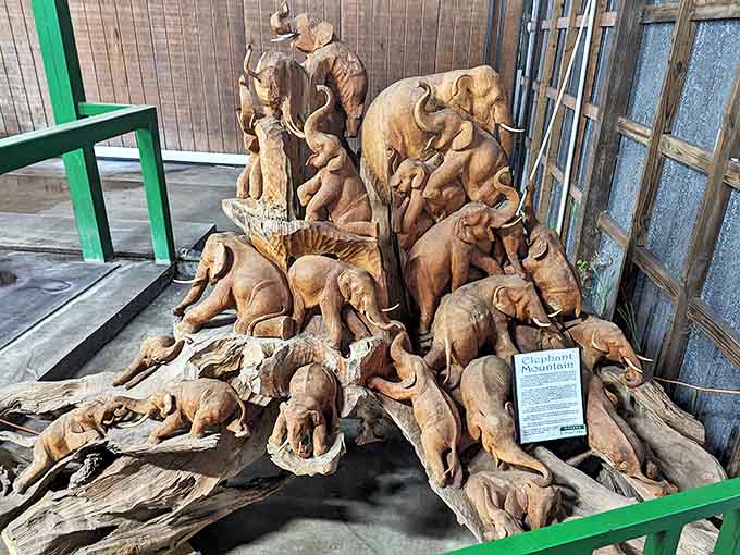 This intricate wooden sculpture captures the essence of elephant family life, a masterpiece of artistry celebrating these magnificent creatures.