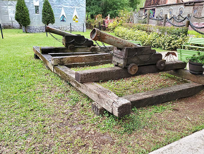 This antique cannon stands ready to defend the realm against imaginary invaders, its wooden wheels and metal barrel showcasing historical craftsmanship.