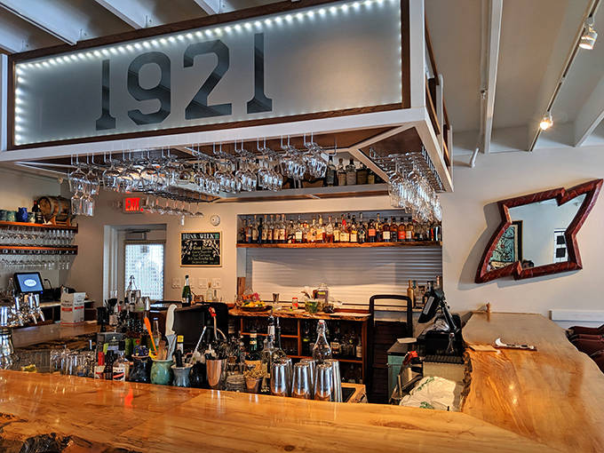 The bar at 1921 isn't just where drinks are made &ndash; it's where liquid artistry happens under the watchful glow of the restaurant's namesake sign.