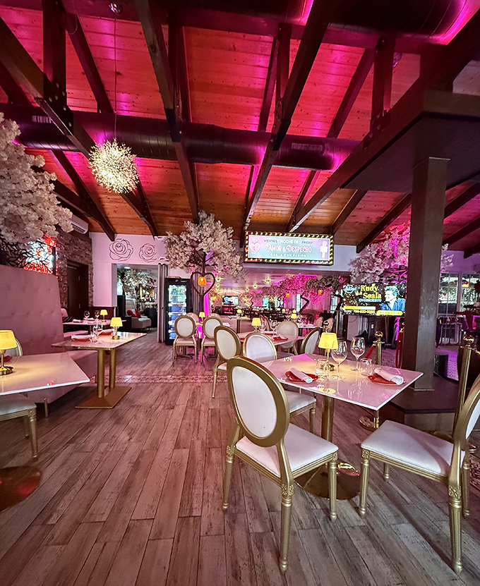 Elegant white chairs and sparkling chandeliers create a dining room that feels both modern and timeless, perfect for special occasions.