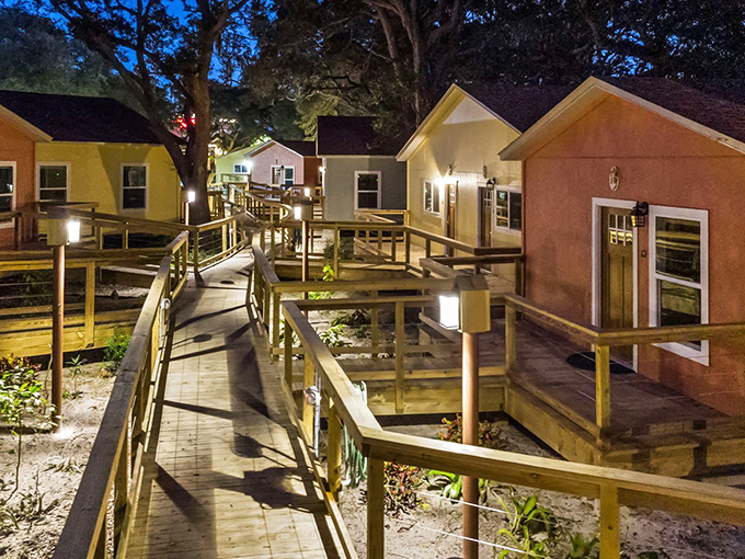 At night, illuminated boardwalks transform the village into an enchanted forest where evening strolls become magical adventures.