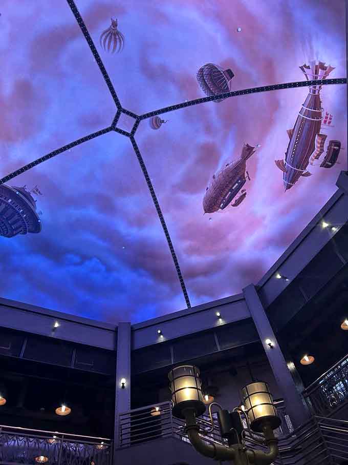 The ceiling design includes floating airships because why wouldn't a chocolate factory have its own fleet of dirigibles?