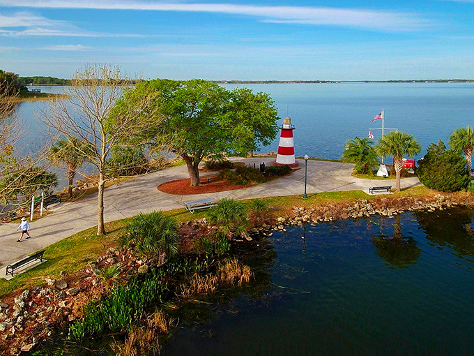 A bird's-eye view reveals how perfectly the lighthouse sits at the point, surrounded by the blue waters of Lake Dora.