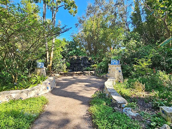 Stone benches frame this serene entrance, inviting contemplation before the garden reveals its botanical treasures.