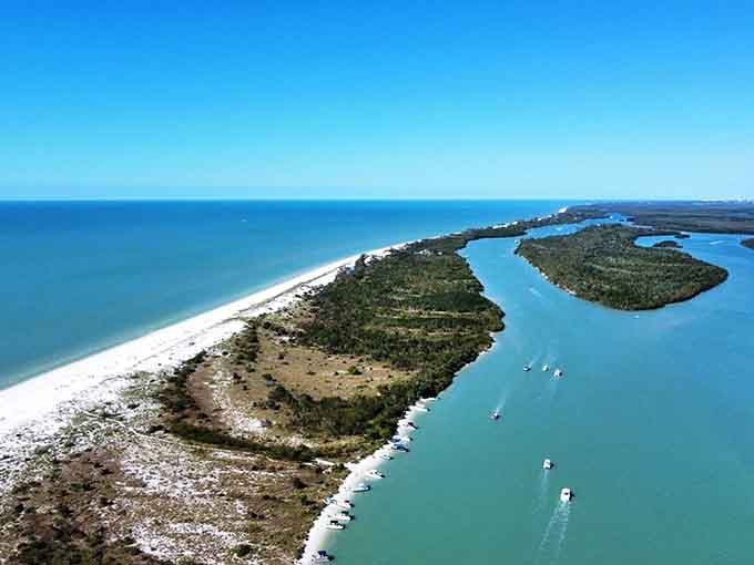 The aerial view shows just how narrow and long Keewaydin stretches, a ribbon of sand separating the Gulf from the bay like nature's perfect divider.