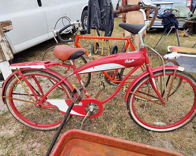 A vintage bicycle stands ready for its next adventure &ndash; its cherry-red frame a beacon of nostalgic transportation.