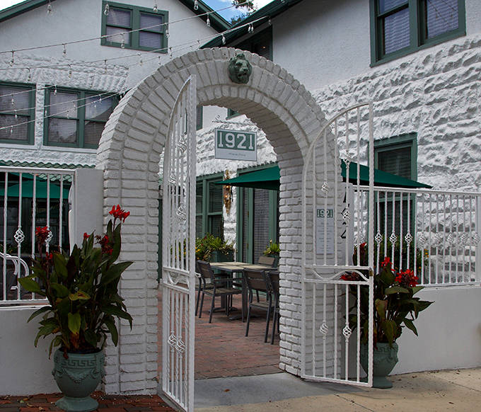 The iconic white archway entrance &ndash; a portal between the ordinary world and 1921's extraordinary culinary universe.