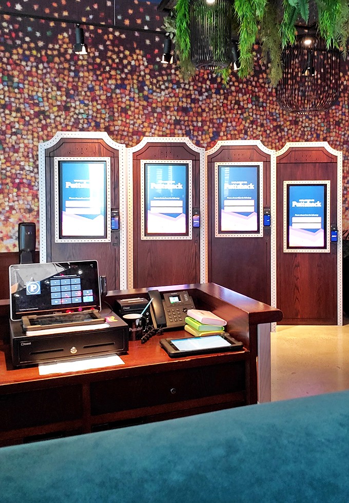 The reception area blends retro wood paneling with modern technology – a perfect metaphor for Puttshack's reinvention of a classic pastime.