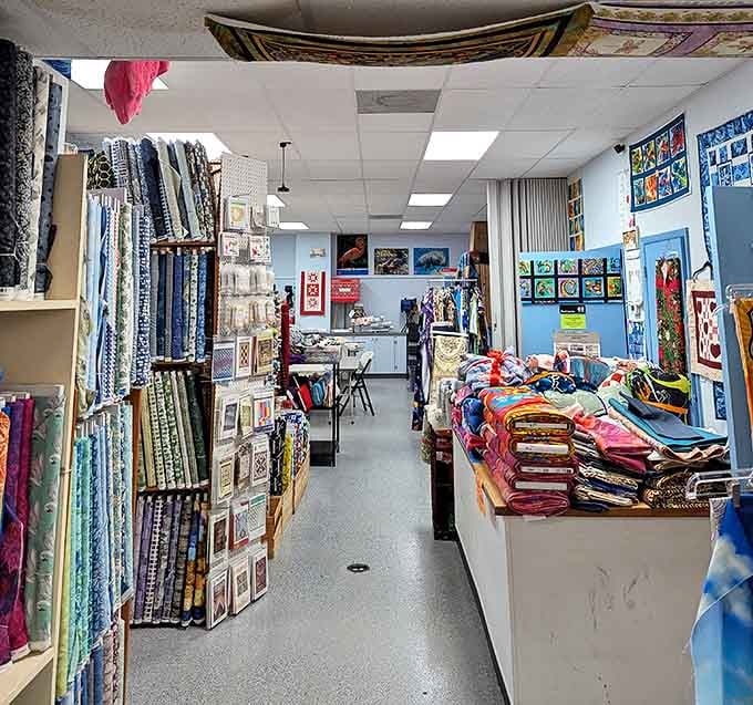 Bolts of fabric create a textile library where every shelf tells a different story. Color-coordinated heaven for the organizationally obsessed.