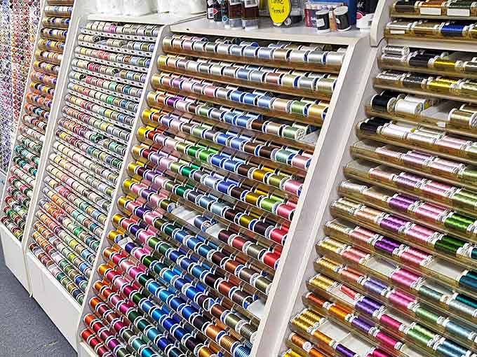 The thread wall – where indecision becomes an art form. More colors than a sunset, arranged with the precision of a NASA launch.