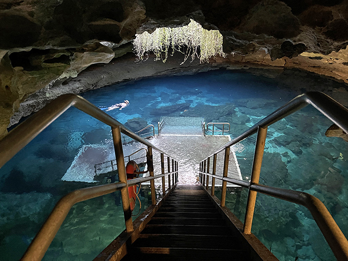 Stairway to paradise: Metal steps lead visitors down to crystal-clear waters that have remained 72 degrees for millennia.