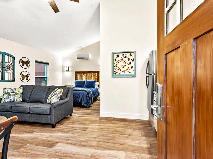 The open-concept living area features comfortable seating, vaulted ceilings, and large windows that bring the surrounding nature indoors.