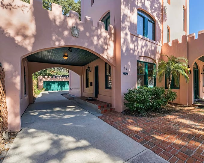 The castle's arched entryway welcomes visitors with Mediterranean flair, the green ceiling adding an unexpected pop of color.
