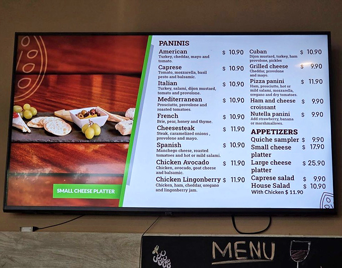 The menu board reveals panini options and chocolate dreams, because even paradise needs some savory balance occasionally.