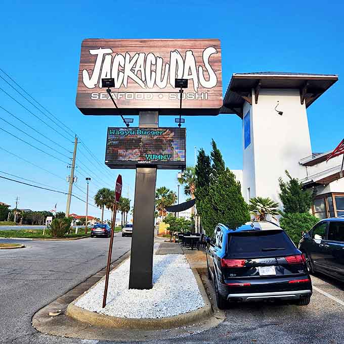 The distinctive wooden Jackacuda's sign towers above Destin's landscape, a beacon for seafood and sushi lovers seeking something beyond the ordinary.