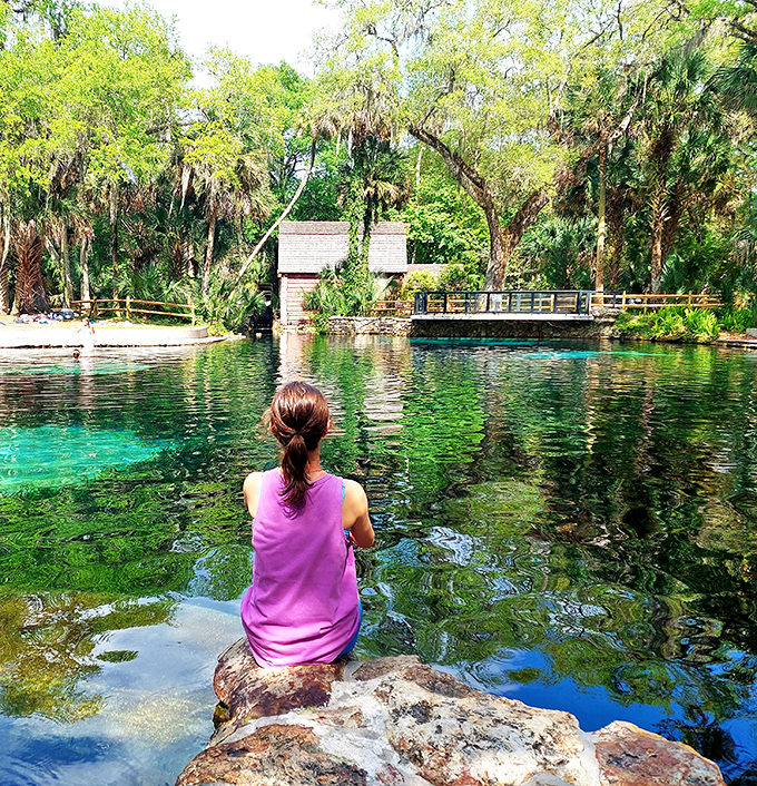 A peaceful moment by the spring's edge, where the turquoise waters invite contemplation and the occasional cannonball for those less philosophically inclined.