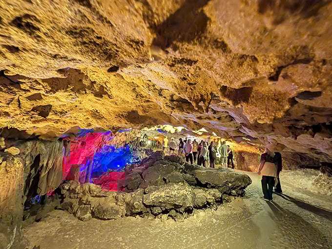 Vibrant colored lights reveal the cavern's hidden personality, turning an ordinary cave tour into a psychedelic underground journey.