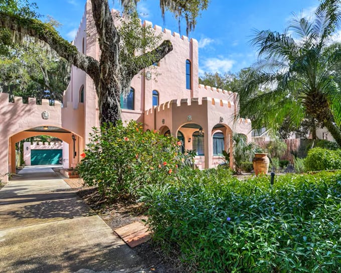 Ancient oaks frame the castle's distinctive silhouette, their Spanish moss creating nature's perfect accessory for this architectural gem.