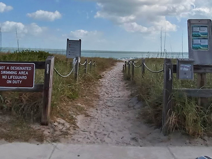 The entrance says it all: "No lifeguard on duty" translates to "authentic Florida beach experience ahead." Consider yourself warned&mdash;and invited.