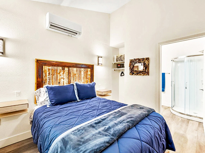 Sweet dreams come easily in bedrooms featuring custom wooden headboards and plush bedding in soothing ocean-inspired blues.