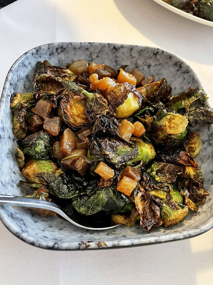 Brussels sprouts that could convert vegetable skeptics &ndash; caramelized with candied pork belly and a whiskey gastrique that makes "eating your greens" a pleasure.