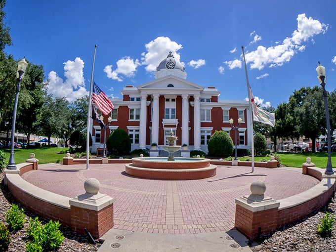 The historic courthouse stands as Dade City's crown jewel, surrounded by brick pathways and lush Florida greenery.