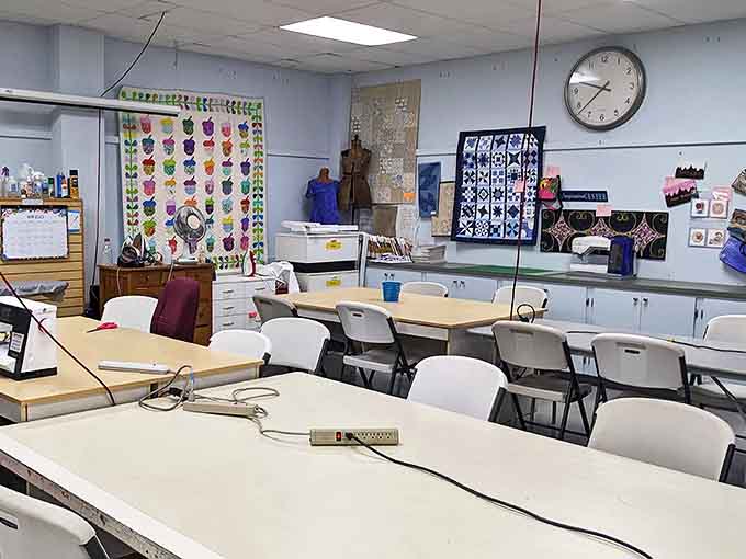 The classroom awaits creative minds, where fabric dreams become tangible reality. Those chairs have witnessed countless "eureka" moments.