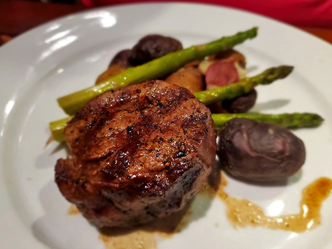 Tender steak cooked to perfection alongside roasted potatoes and bright asparagus &ndash; proof that landlubbers eat royally at this seafood haven.