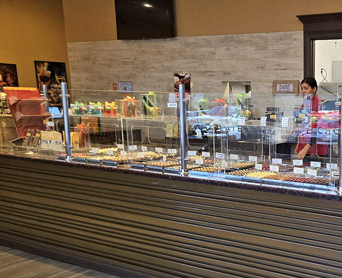 Behind the counter, chocolate selections multiply like delicious possibilities, making decision-making both difficult and delightful.