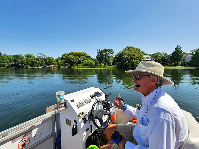 Captain at the helm, sharing tales of local lore with the practiced ease of someone who knows these waters like the back of their hand.
