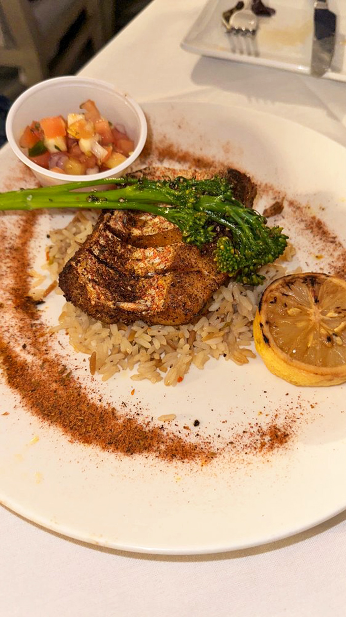 Blackened snapper resting on a bed of rice, surrounded by a dusting of spices that would make any Floridian fisherman proud.