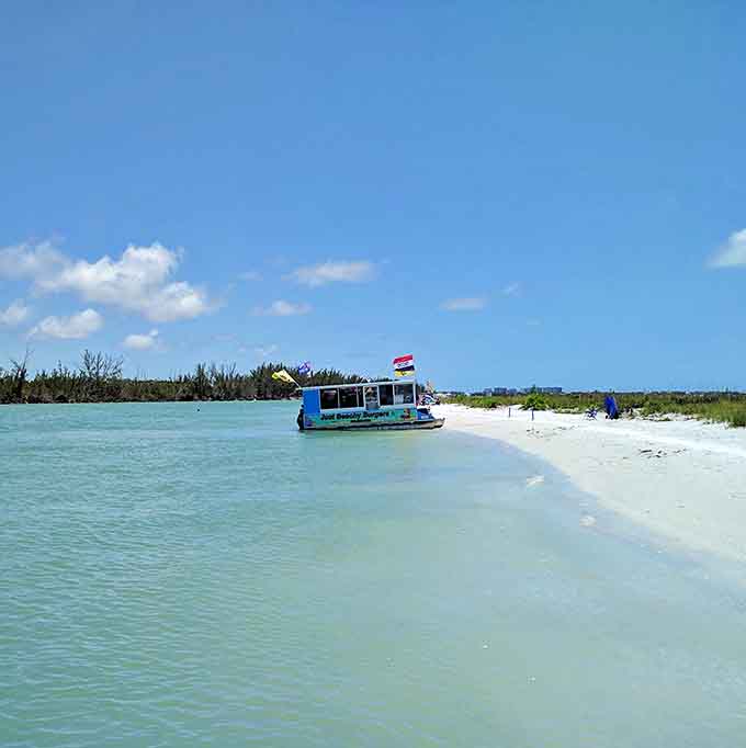 The floating restaurant fleet anchored in crystal-clear water creates a scene that looks Photoshopped but is somehow completely, wonderfully real.