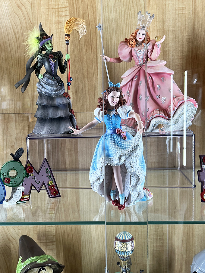 Intricate figurines capture the iconic characters in exquisite detail, from Glinda's pink gown to the Wicked Witch's dramatic black ensemble and pointed hat.