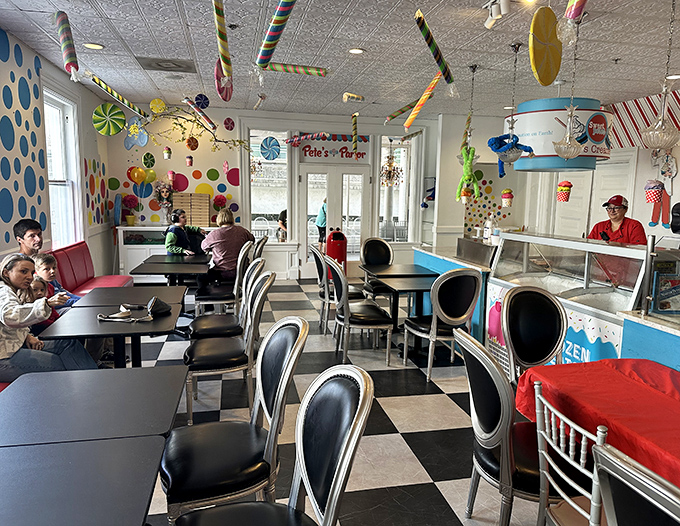 Pete's Parlor dining area combines nostalgic soda fountain vibes with modern whimsy &ndash; checkered floors meet ceiling candy decorations.