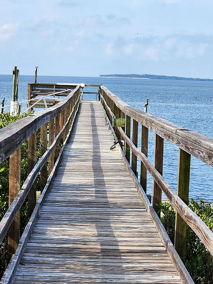 This boardwalk leads to contemplation and probably a cold beverage, stretching toward horizons that erase your worries.