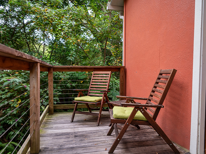Each cottage features a private deck where morning coffee becomes a zen moment among the rustling leaves and filtered sunlight.