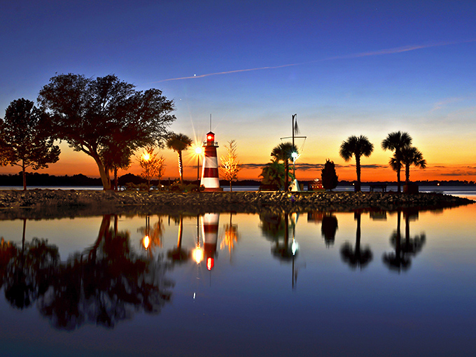 As darkness falls, the lighthouse comes alive, its blue pulsating light reflecting off the water like a heartbeat.