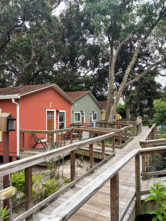 Elevated boardwalks wind through lush vegetation, creating magical pathways that connect the colorful cottages while preserving nature below.